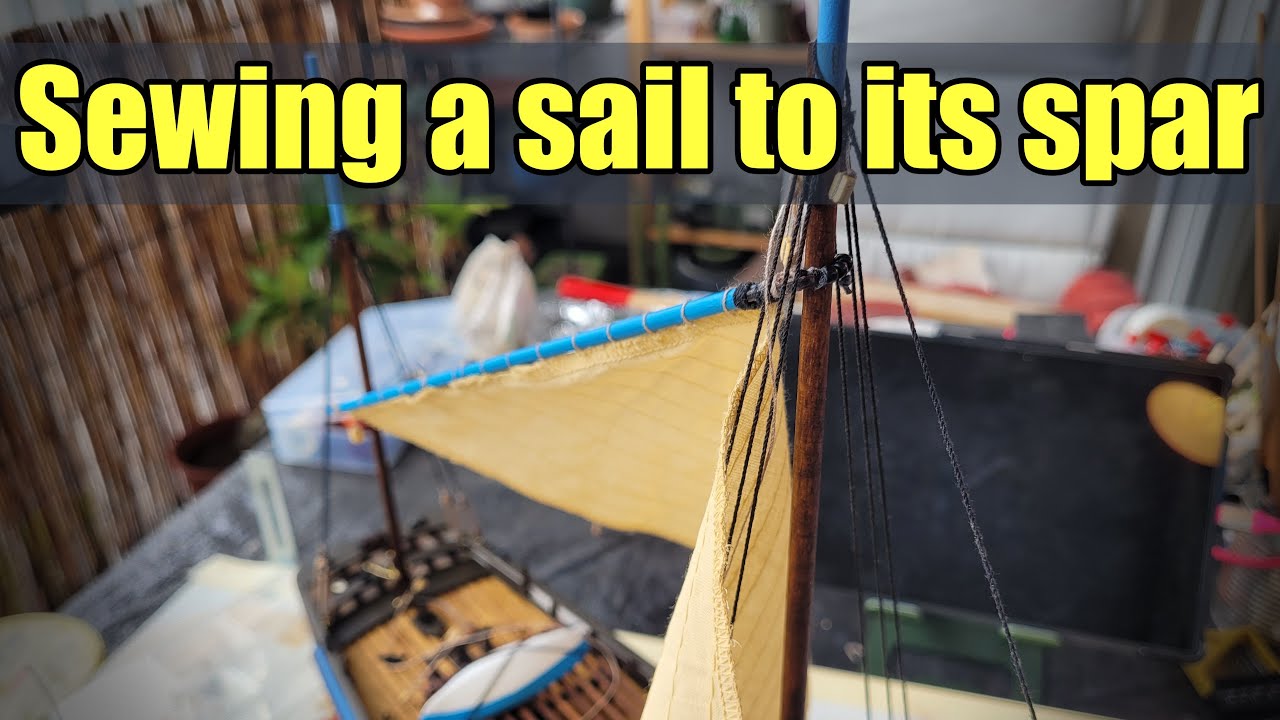 Ship model building: sewing a sail to its spar - YouTube