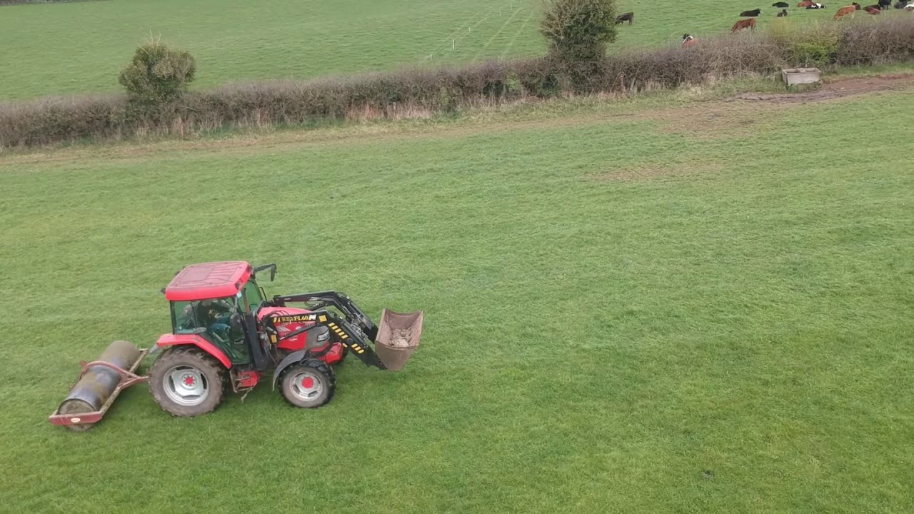 Rolling silage ground - YouTube