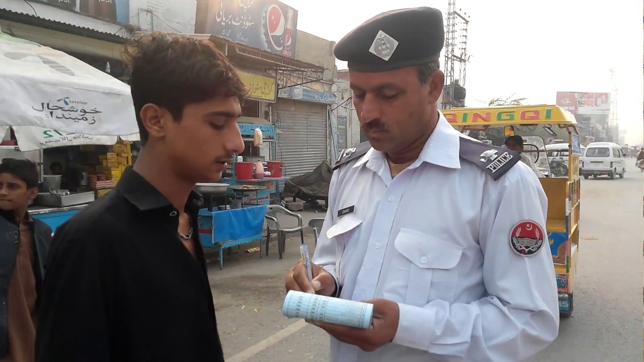 traffic police chakwal giving chalan (fine) receipt to a under age ...