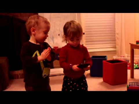 kids playing with animal sounds app on tablet and dump truck