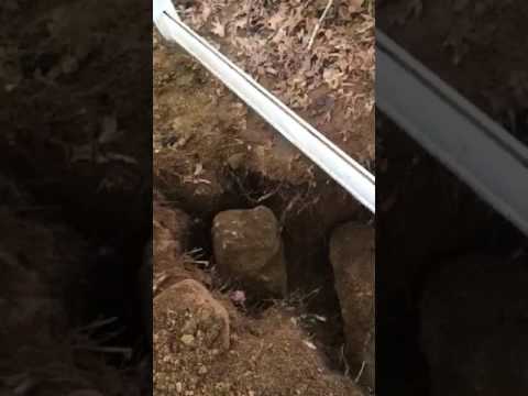 how to break up Large rock in post hole by hand in fence - YouTube