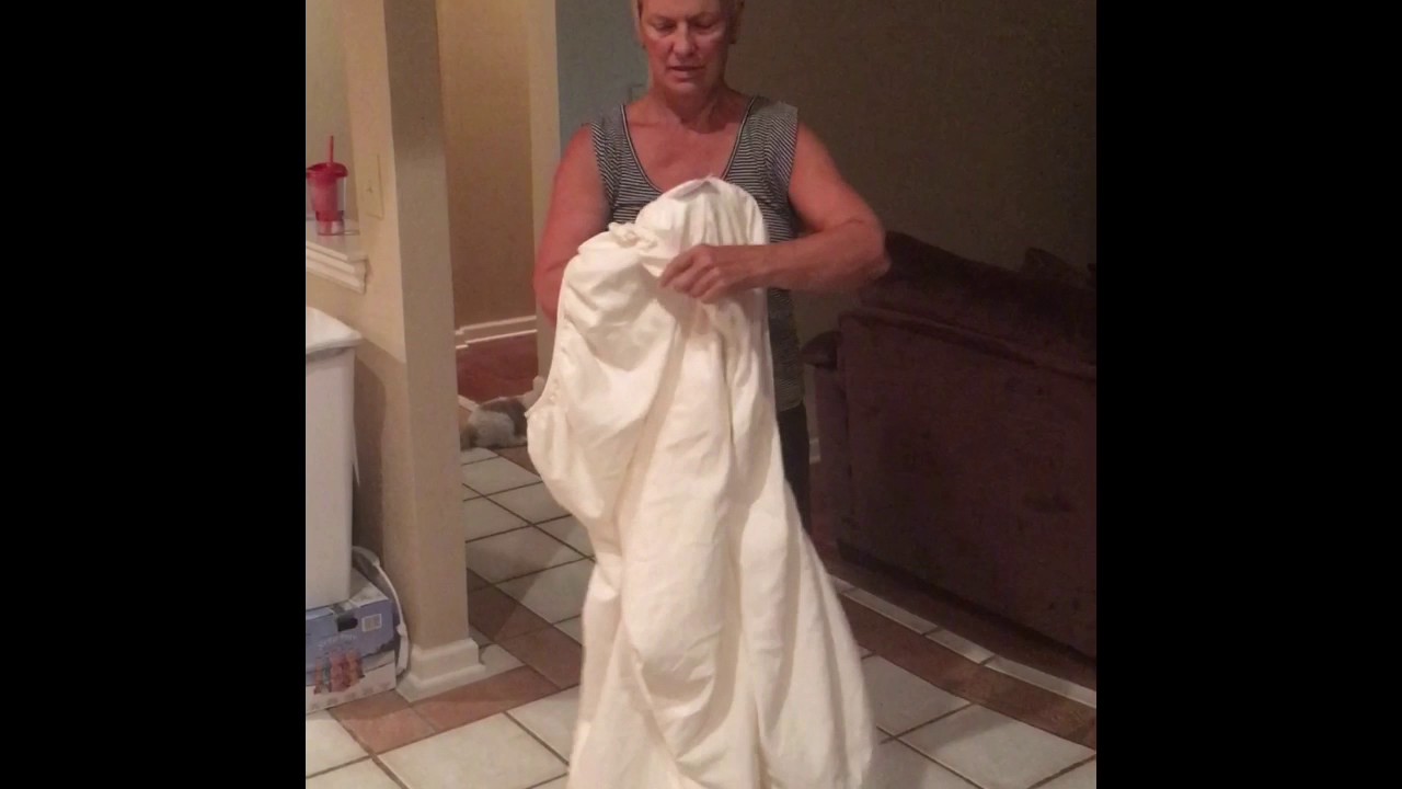 Woman Figures Out How To Fold Fitted Sheet - YouTube