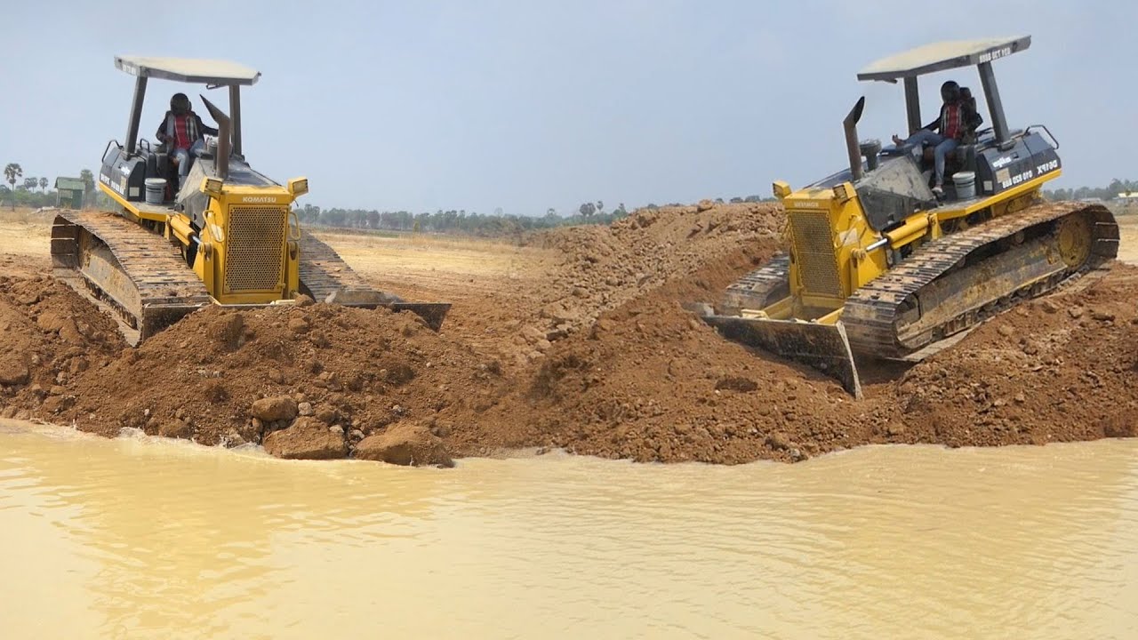 Great job, Bulldozer is doing a quick job of clearing the soil into and ...