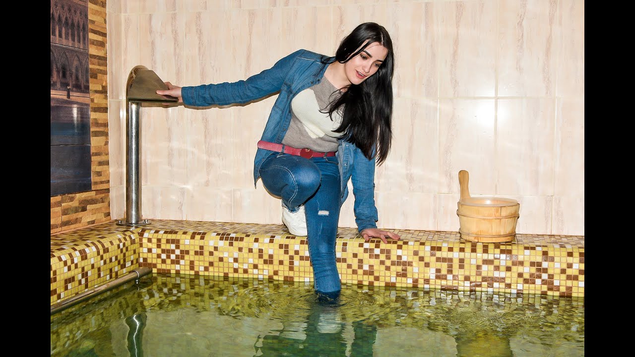 young girl in wet jeans and a wet denim jacket posing in the pool for ...