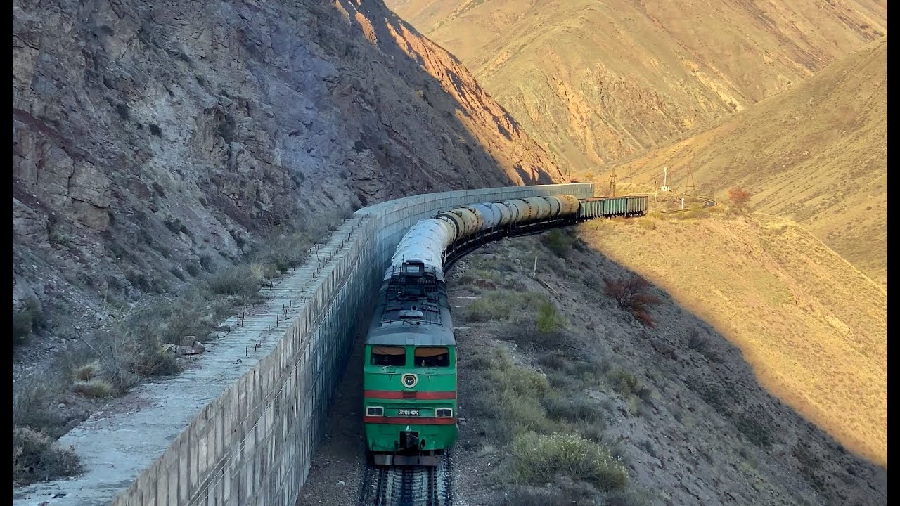 Diesel locomotive 2TE10V-4002 with a freight train makes a stop before ...