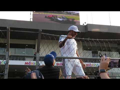 LEWIS HAMILTON CLIMBS THE FENCE IN MEXICO CITY.