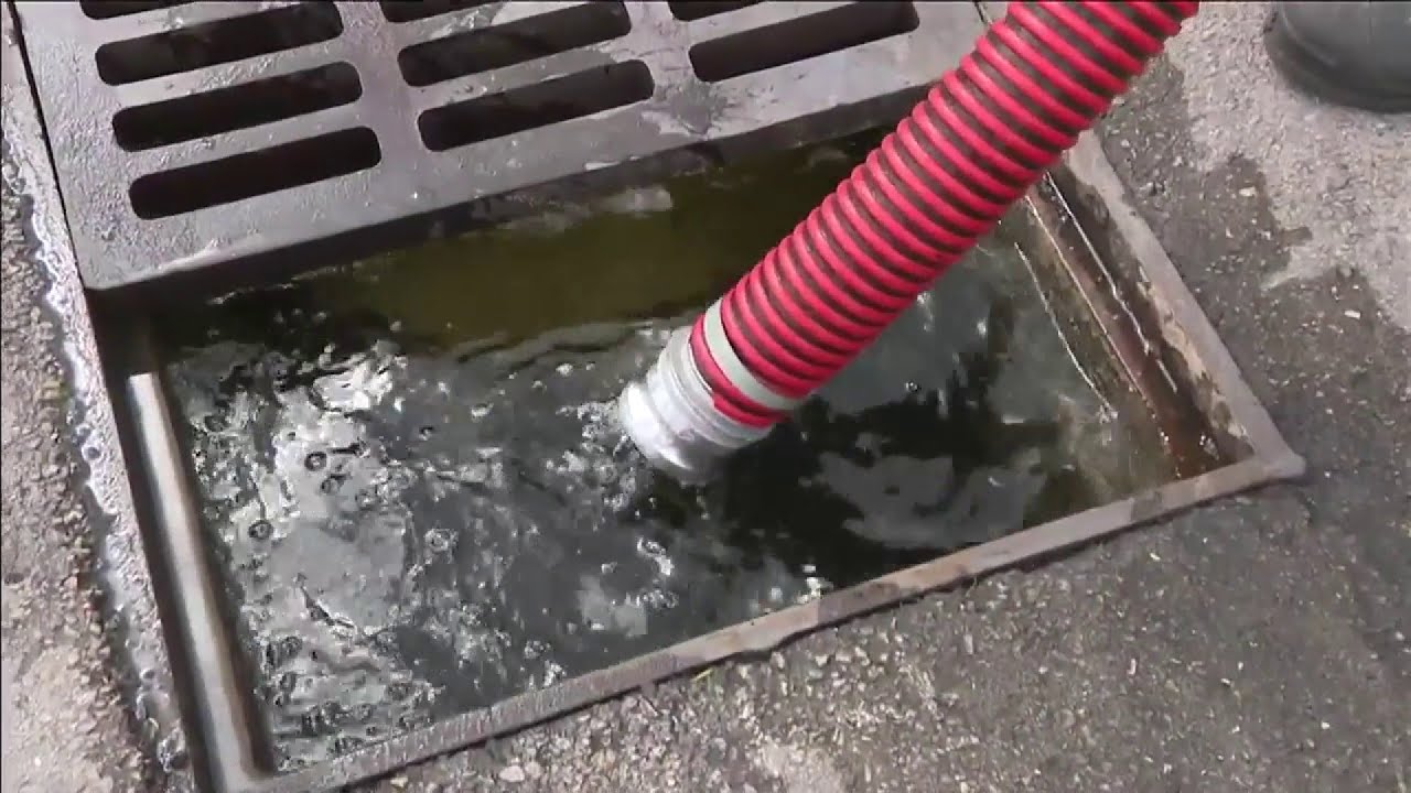 Crews clear storm drains in preparation for Eta - YouTube
