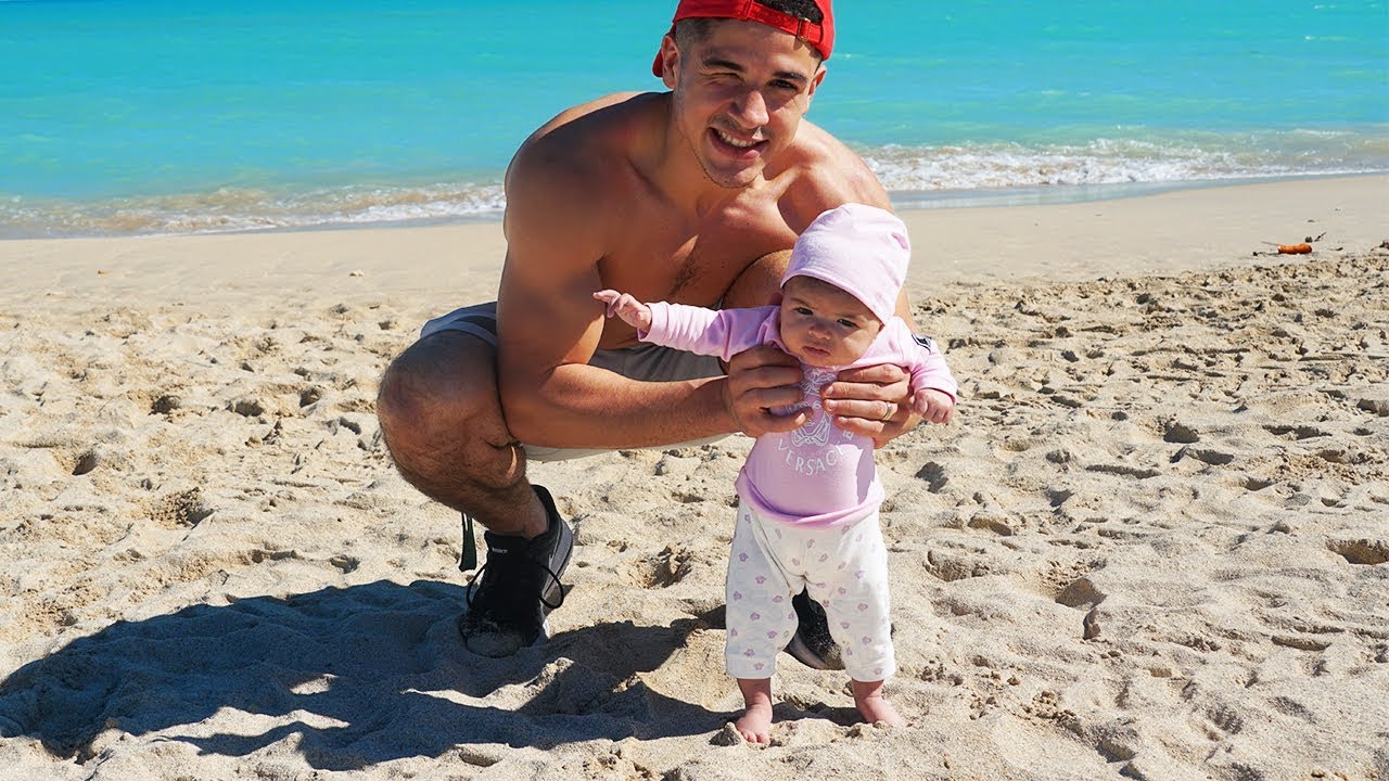 BABY'S FIRST TIME TOUCHING SAND *ADORABLE REACTION* - YouTube