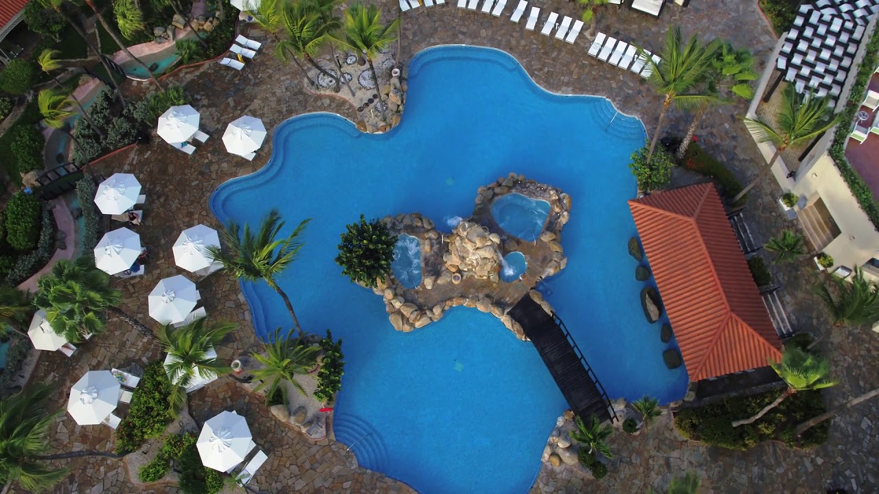 aerial drone shot over tropical resort pool hotel swimming - YouTube