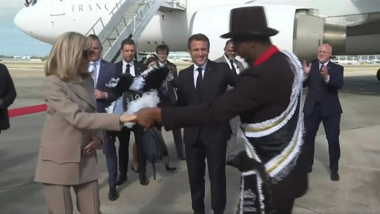 French President Macron dances as he arrives at the airport in New ...