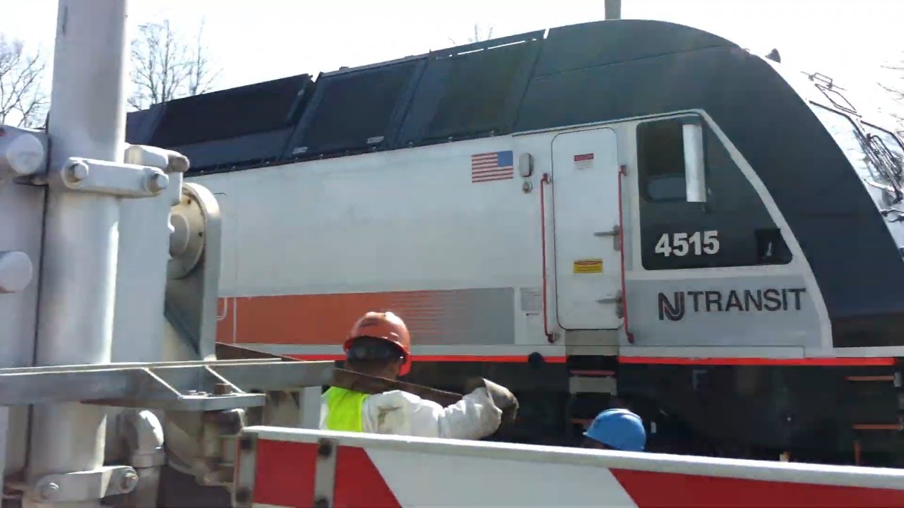 2 Trains pass through level crossing under construction - YouTube
