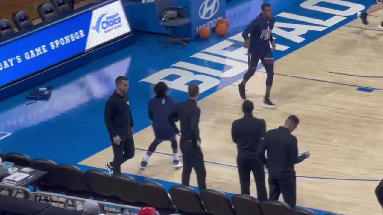 UB men's basketball coach George Halcovage III takes the court before ...