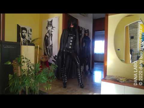 DANA LABO - the woman in black, latex catsuit, gloves, corset, coat and shinny boots,