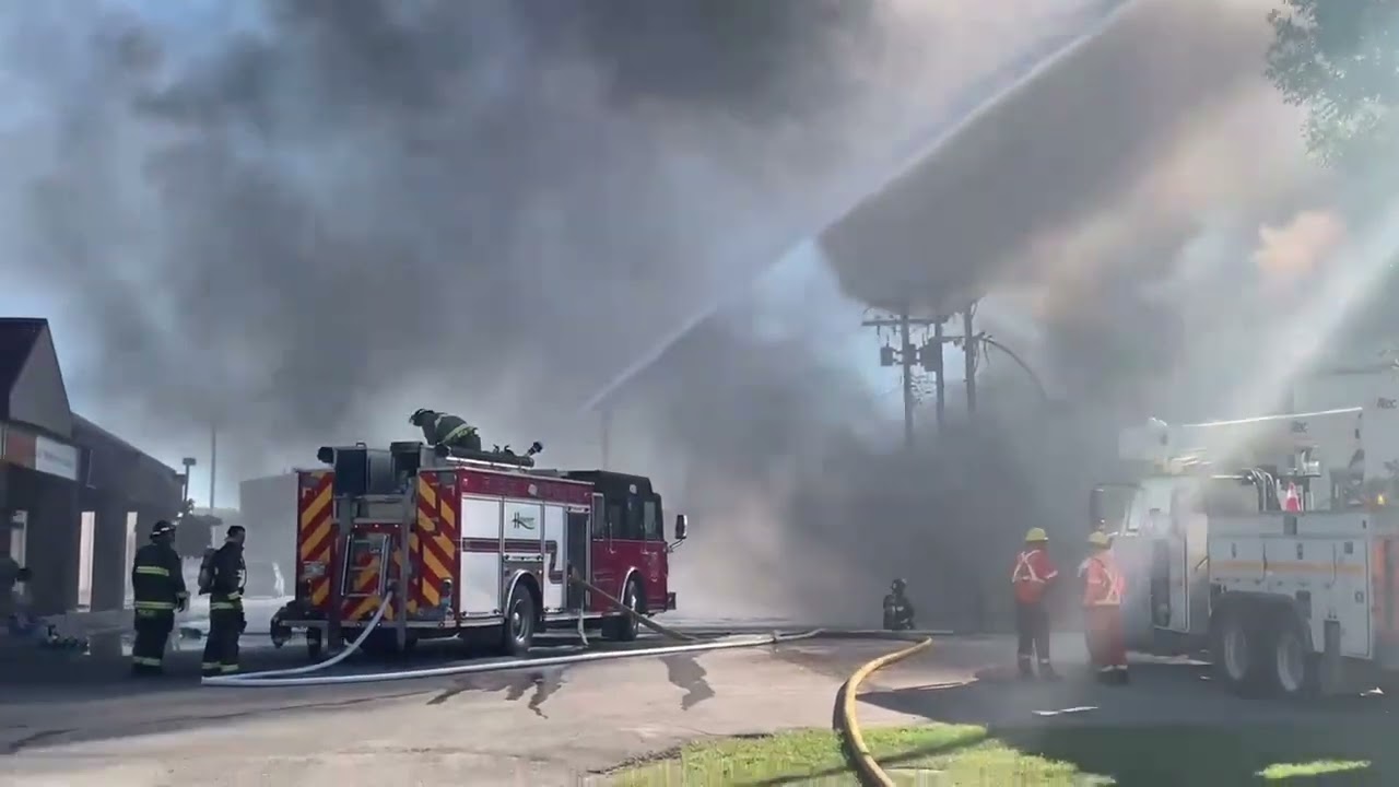 Crowds gather to watch firefighters go to work on Main Street business ...