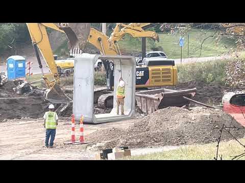 Moving Box Culvert into Position with 2 Excavators. Up Stream Side. Road Construction Project ...