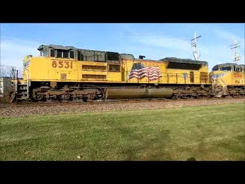 UP 8531 a SD70ACe and UP 3954 a SD70M lead a autorack train west through Geneva IL - YouTube