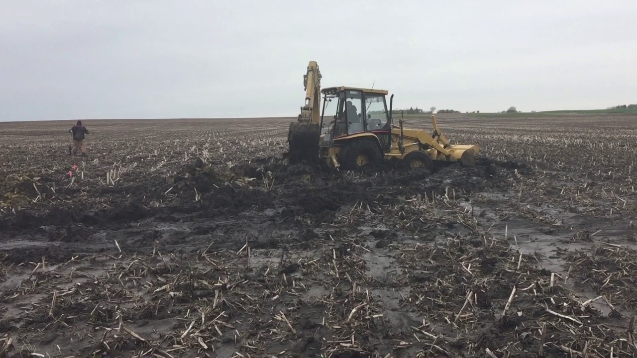 Fixing plugged field tile. - YouTube