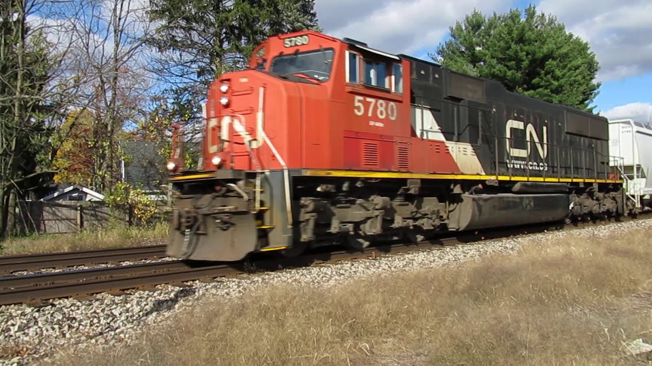 CN 5780 rolls a Westbound freight train with SP/UP hoppers, railgon ...