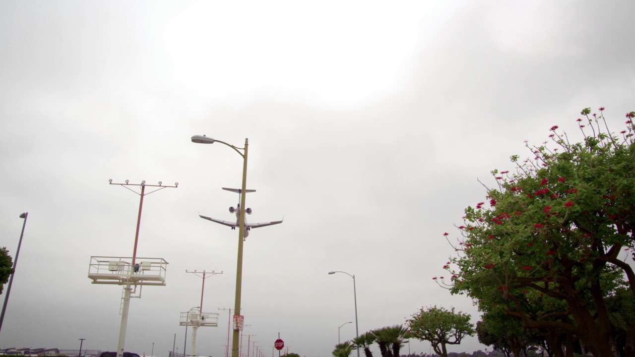 Shot of overhead plane turning and flying over traffic. - YouTube