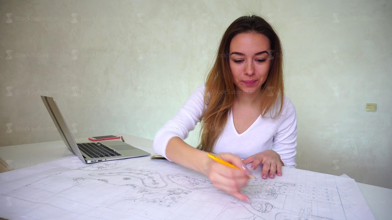Geographer working with map at home, young female finds ideas using ...