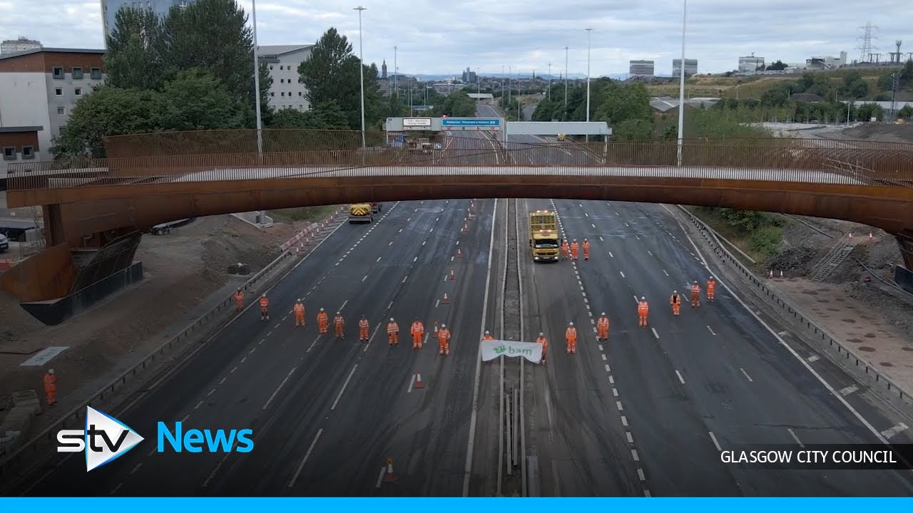 Main span of new cycle and pedestrian bridge over M8 installed - YouTube