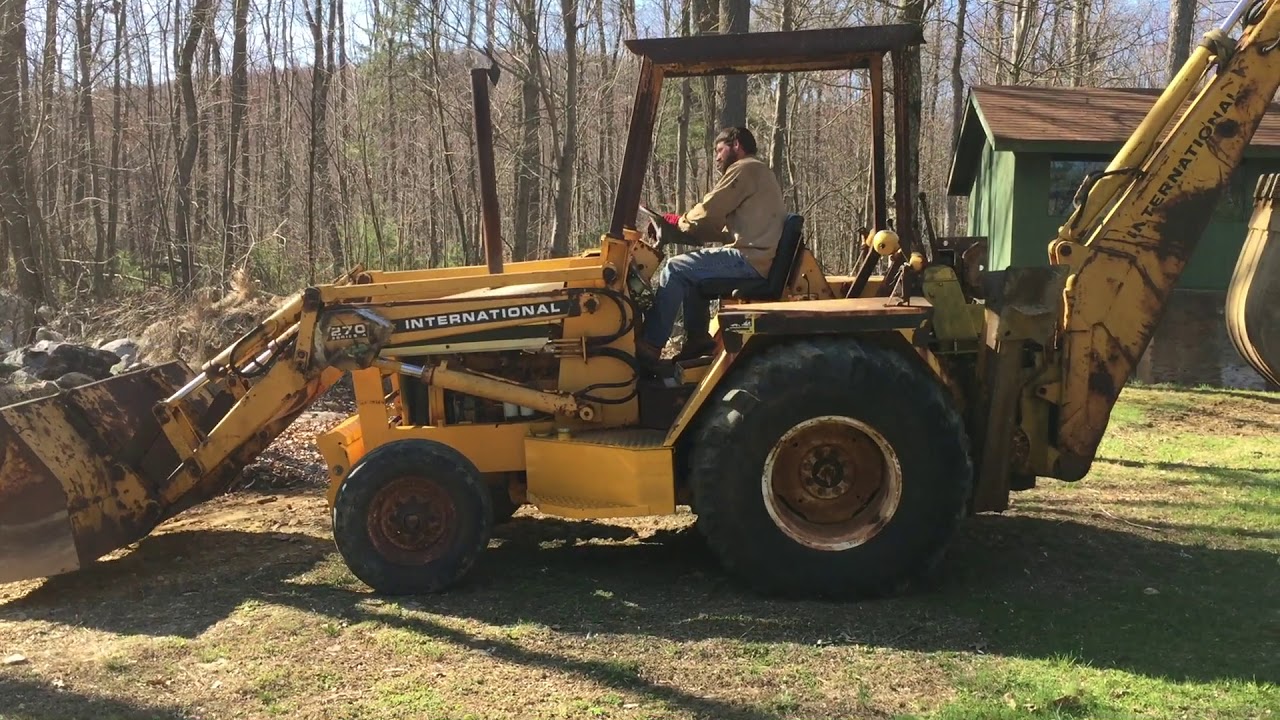 Backhoe moving rocks! - YouTube