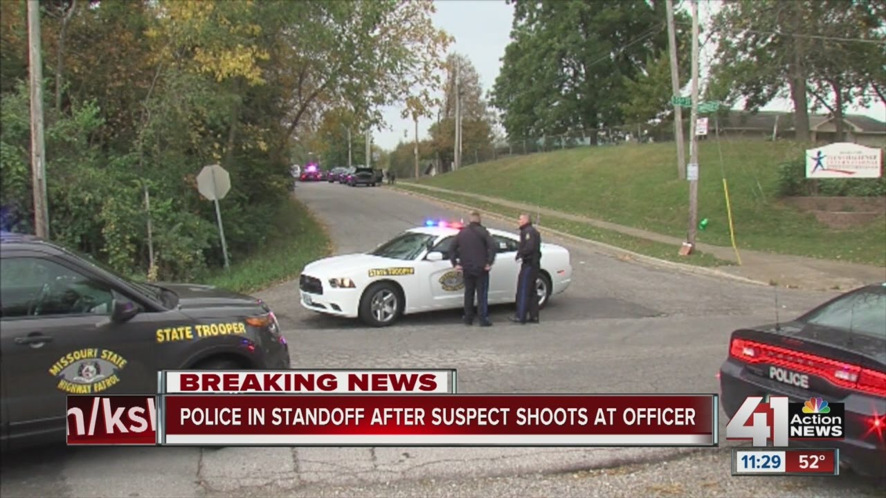 Police in standoff after suspect shoots at officer - YouTube