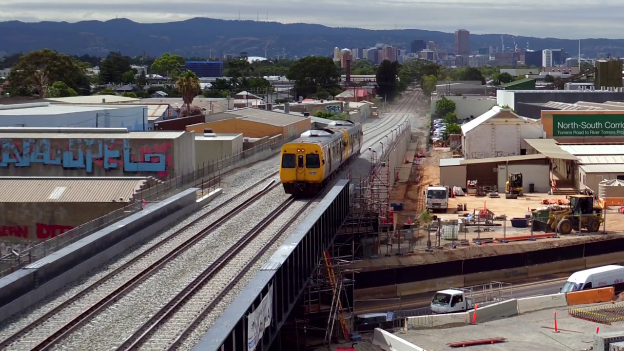 Construction of the Outer Harbor rail overpass and first train - YouTube