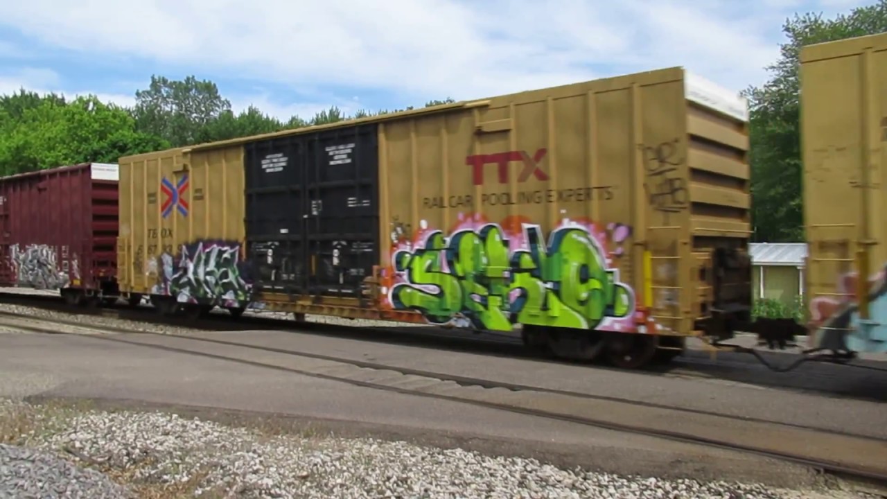 CN 5457, 5721 moving Westbound train with ICG covered hoppers, CN 911 ...