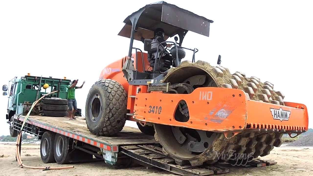 Fuso Self Loader Truck Moving Padfoot Compactor - YouTube