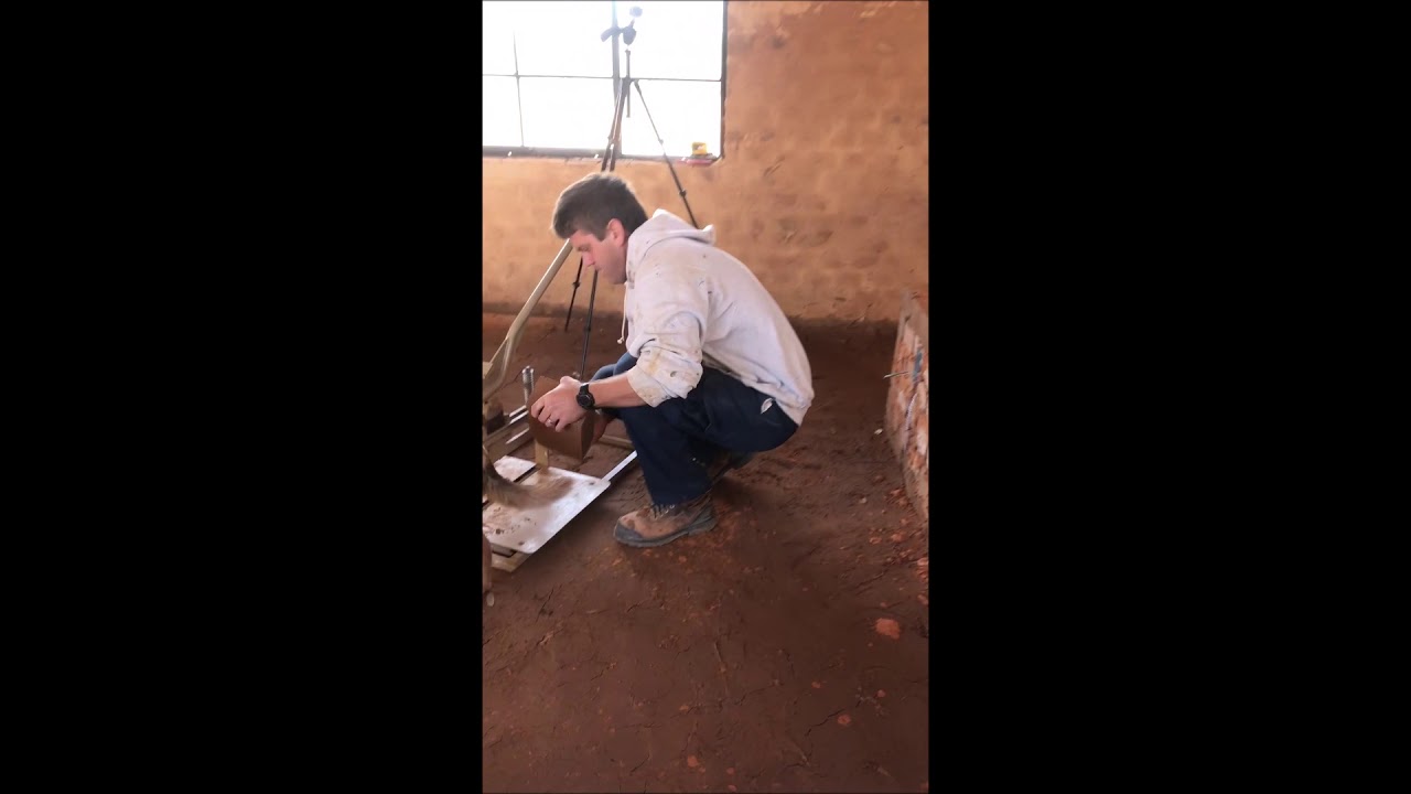 Building an internal CEB wall with AECT compressed earth blocks - YouTube