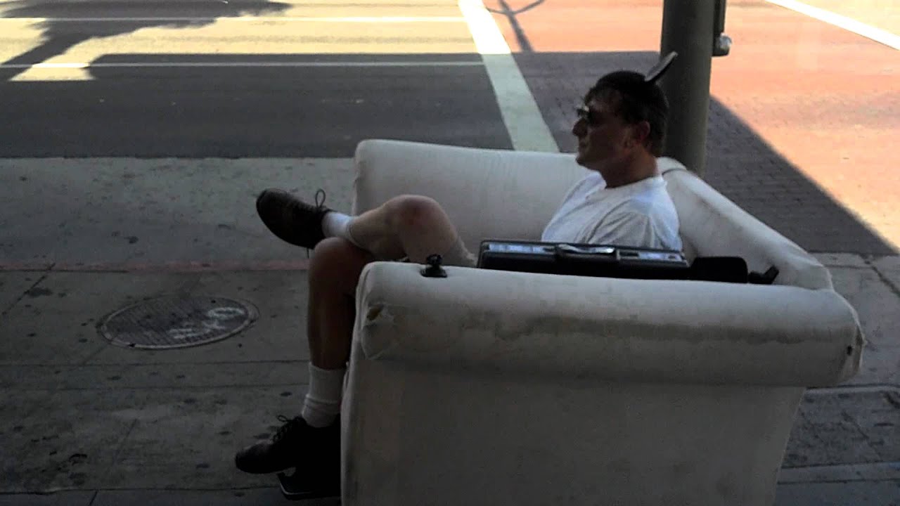 man on rolling couch - YouTube