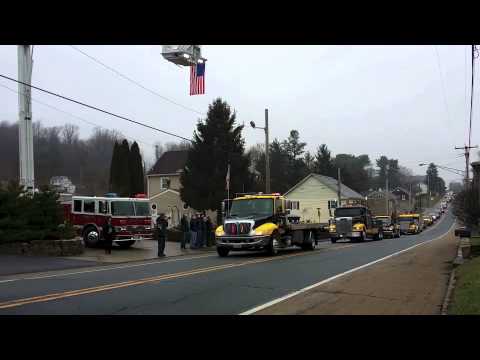 Tow truck funeral procession carries custom-made casket to cemetery ...