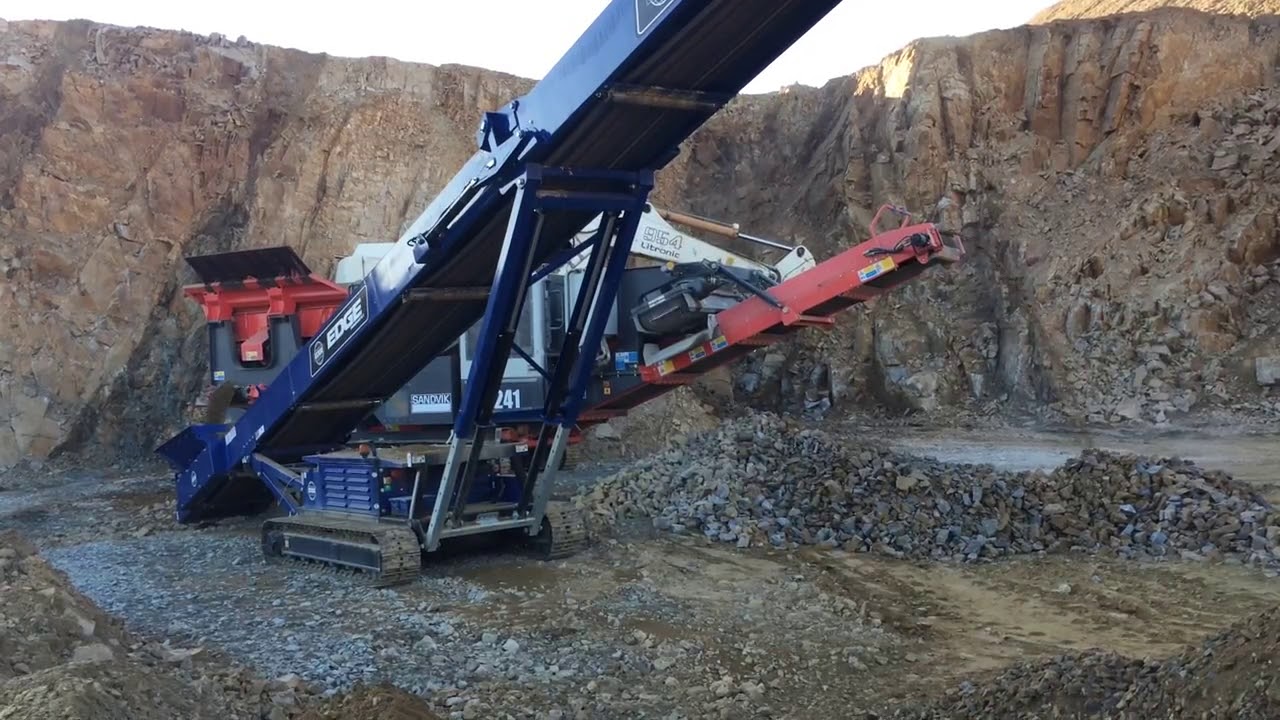 EDGE TS65 stockpiling material from a Sandvik QJ241 - YouTube