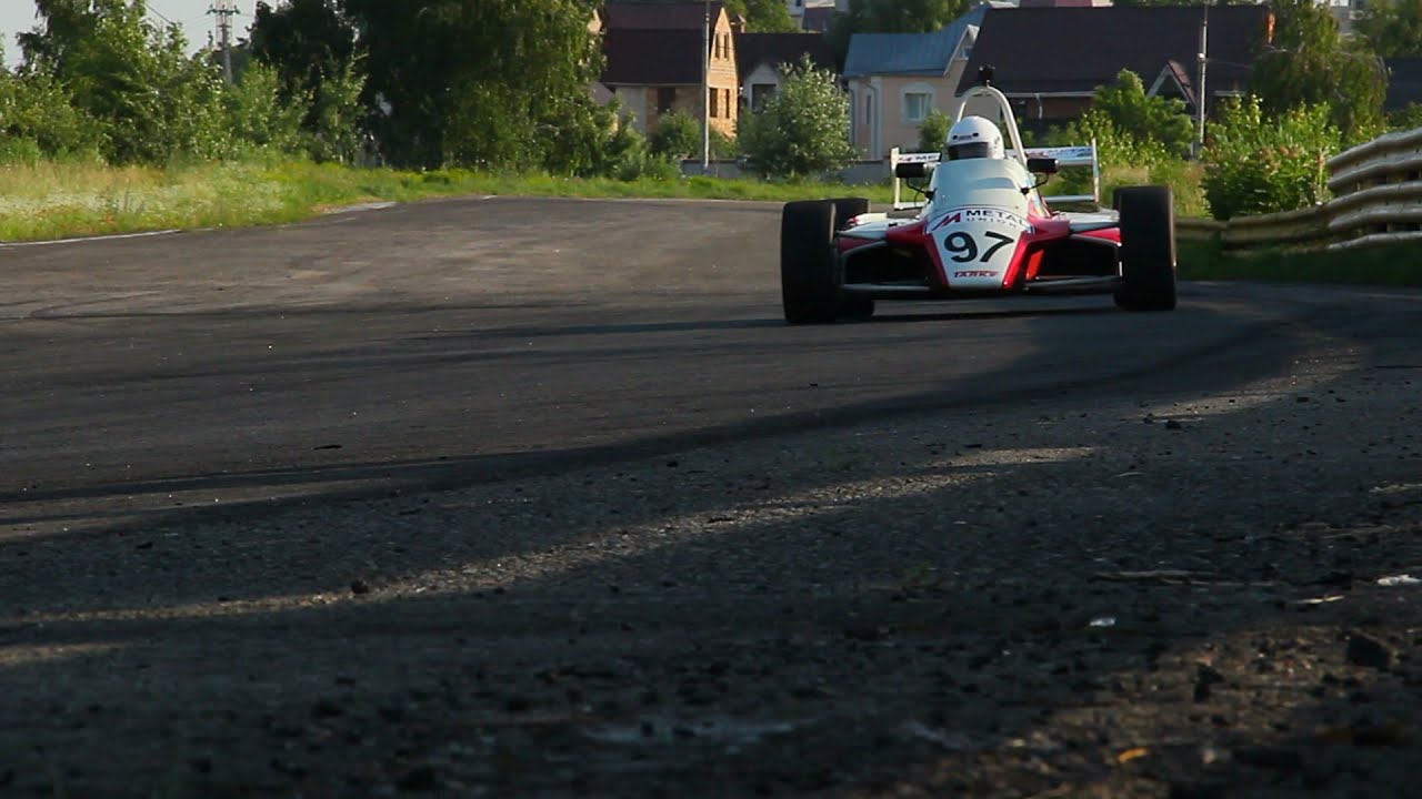 Formula 1 car driving desert circuit, taking fast turn. Stock Footage ...