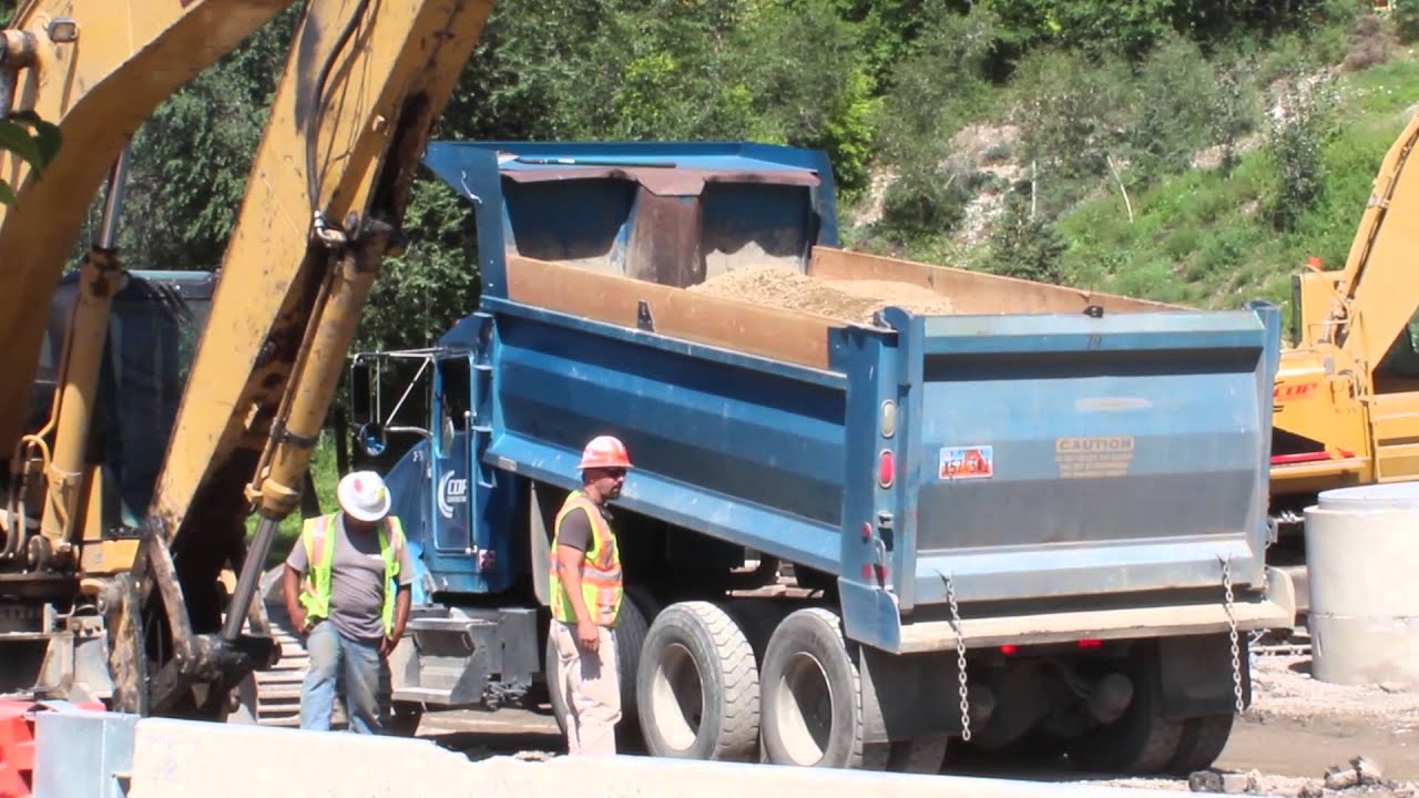 Blue Kenworth Dump Truck dumping dirt on a road construction site - YouTube