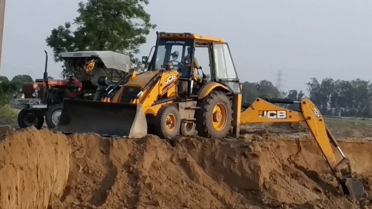 Jcb 3dx working in field leveling - YouTube
