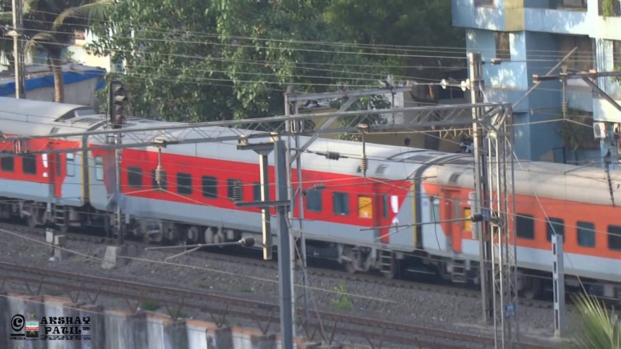 Milky white WAP-7 HOG with Rajdhani express crossing Saurashtra express ...
