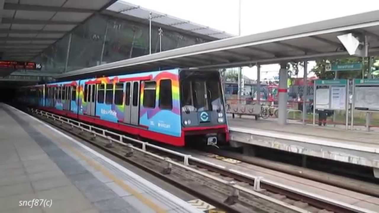 DLR B92 in Ride in Pride livery departs at Stratford - YouTube