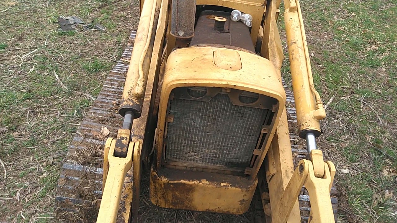 John deere 1010 track loader riding the forks - YouTube