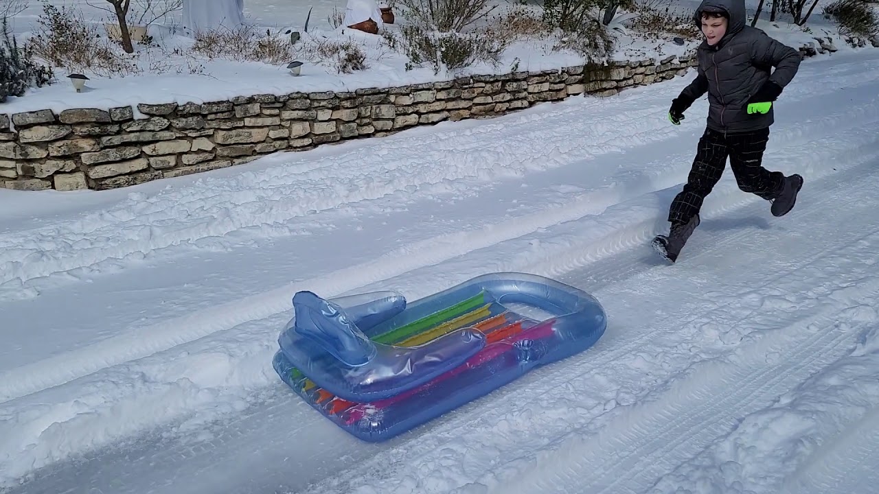Drew using our pool raft as a sled - YouTube