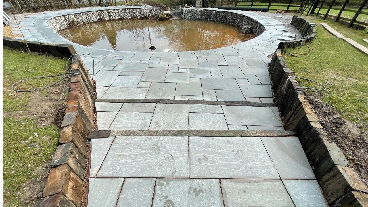 Pointing Up Grey Indian Stone Paving Around This Pond Using A Black ...