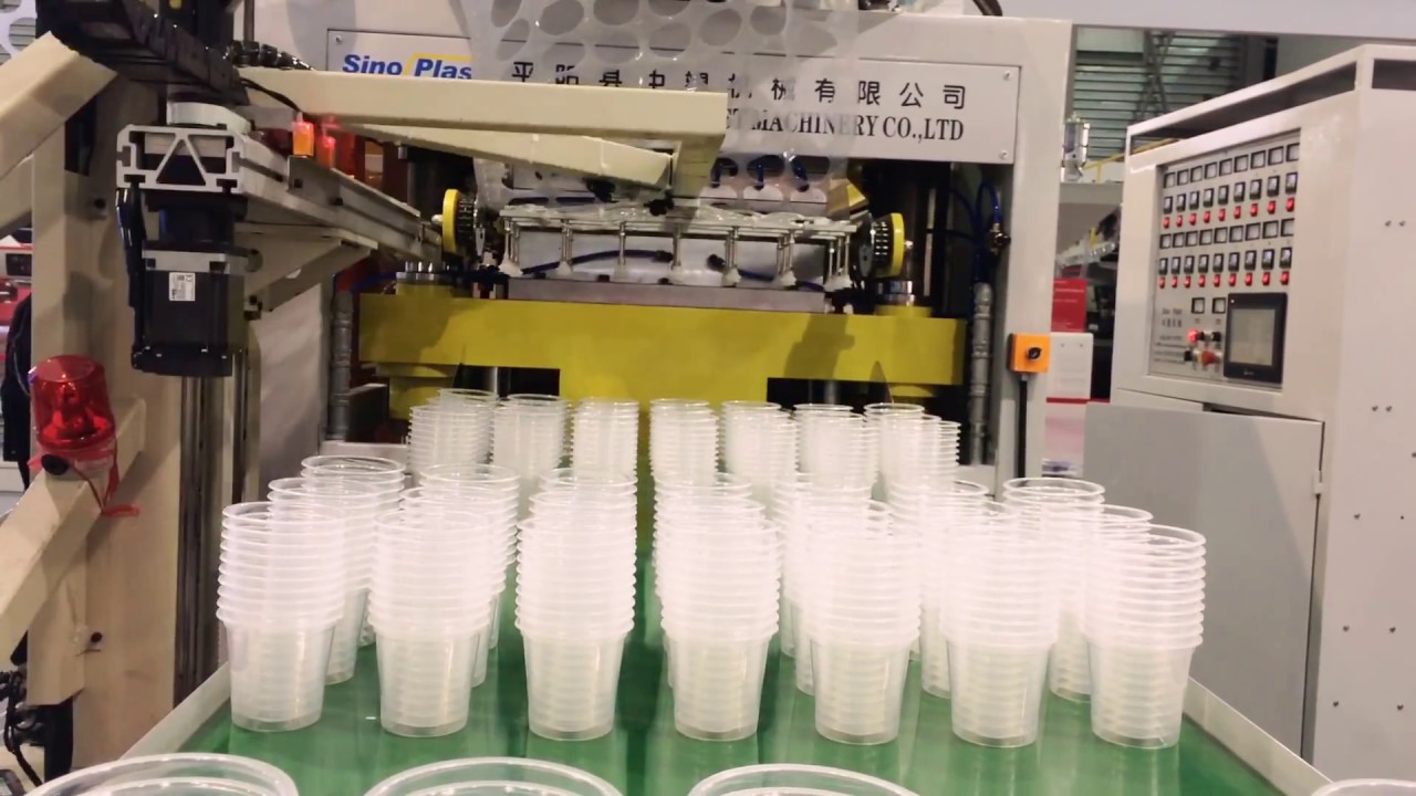 Plastic cup thermoforming machine with robot - YouTube