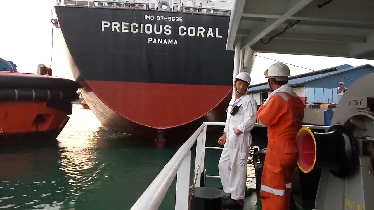 Unberthing cargo ship with 2 tug - YouTube