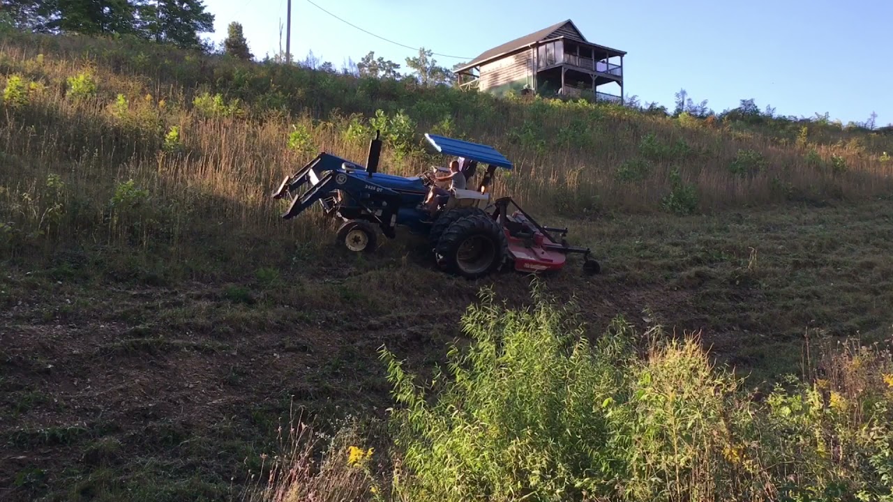 Extreme Bush hogging on steep ground with wet springs Seeping out - YouTube