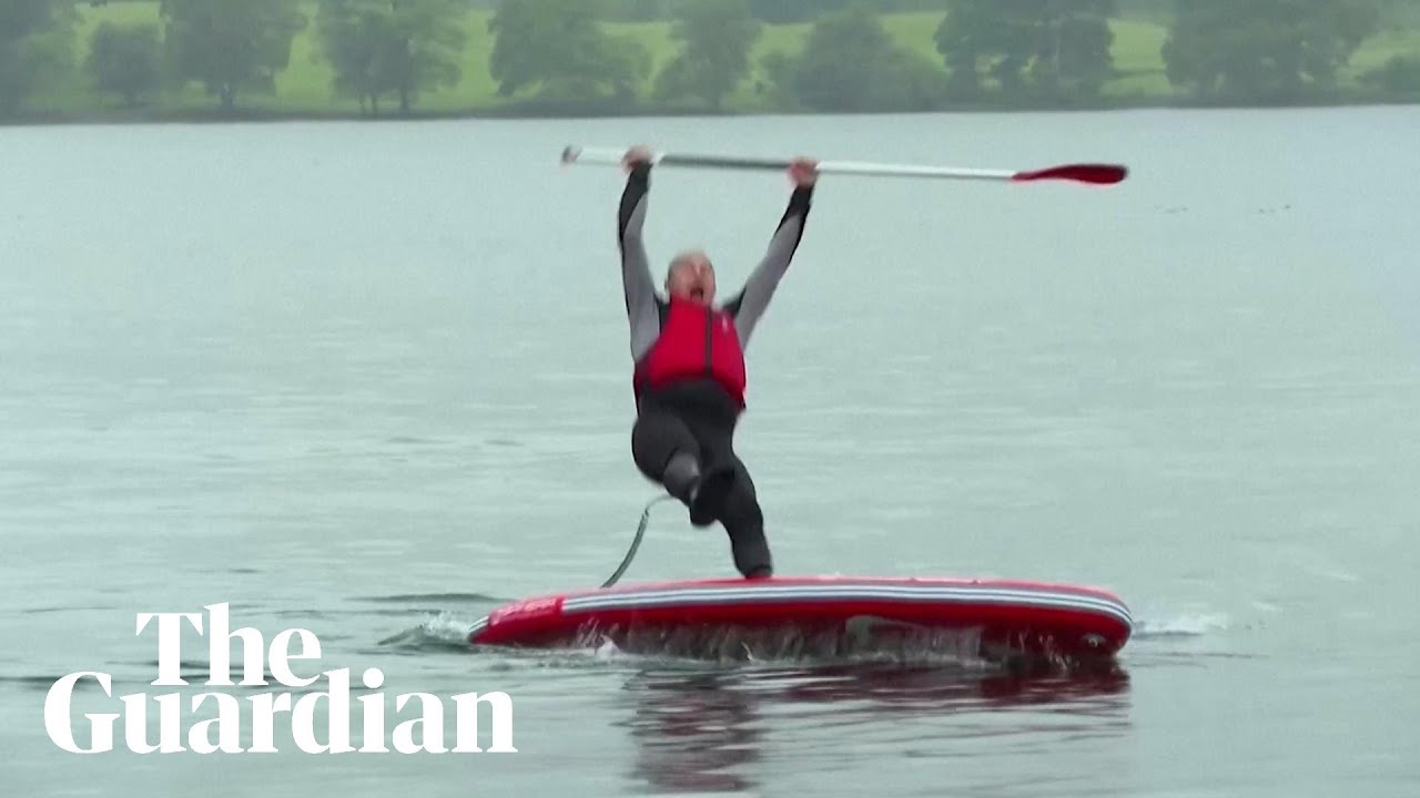 Liberal Democrat leader Ed Davey slips off paddleboard into lake - YouTube
