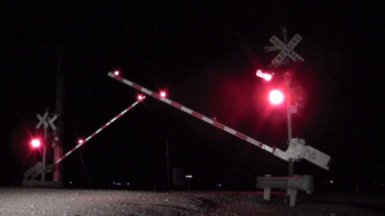 A Beautiful Double Mechanical Bell Crossing At Night as a BNSF Local ...