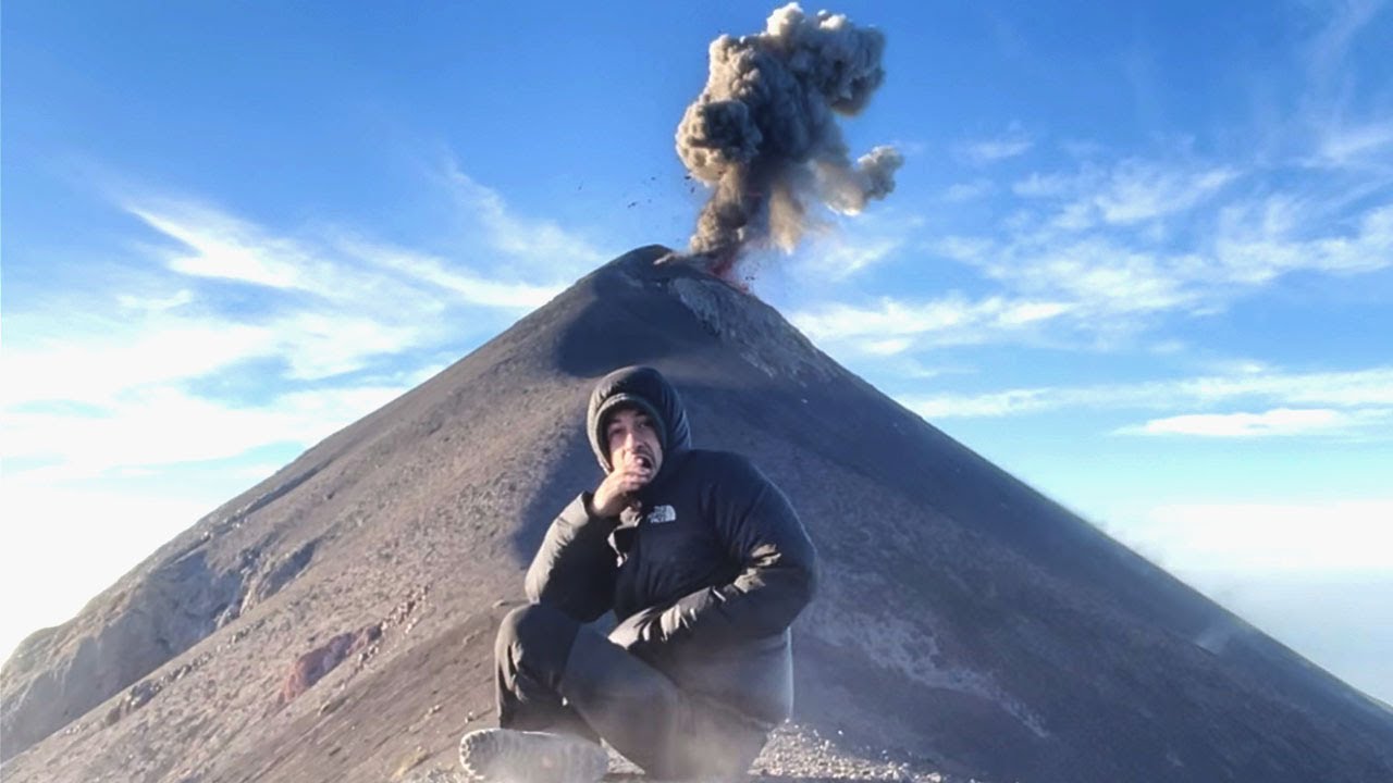 Volcano Erupts Behind Meditating Man - YouTube