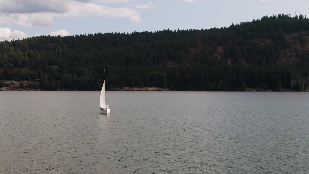 4K BackGround Video : A Sailboat Floating In The Middle Of A Lake | 4K ...