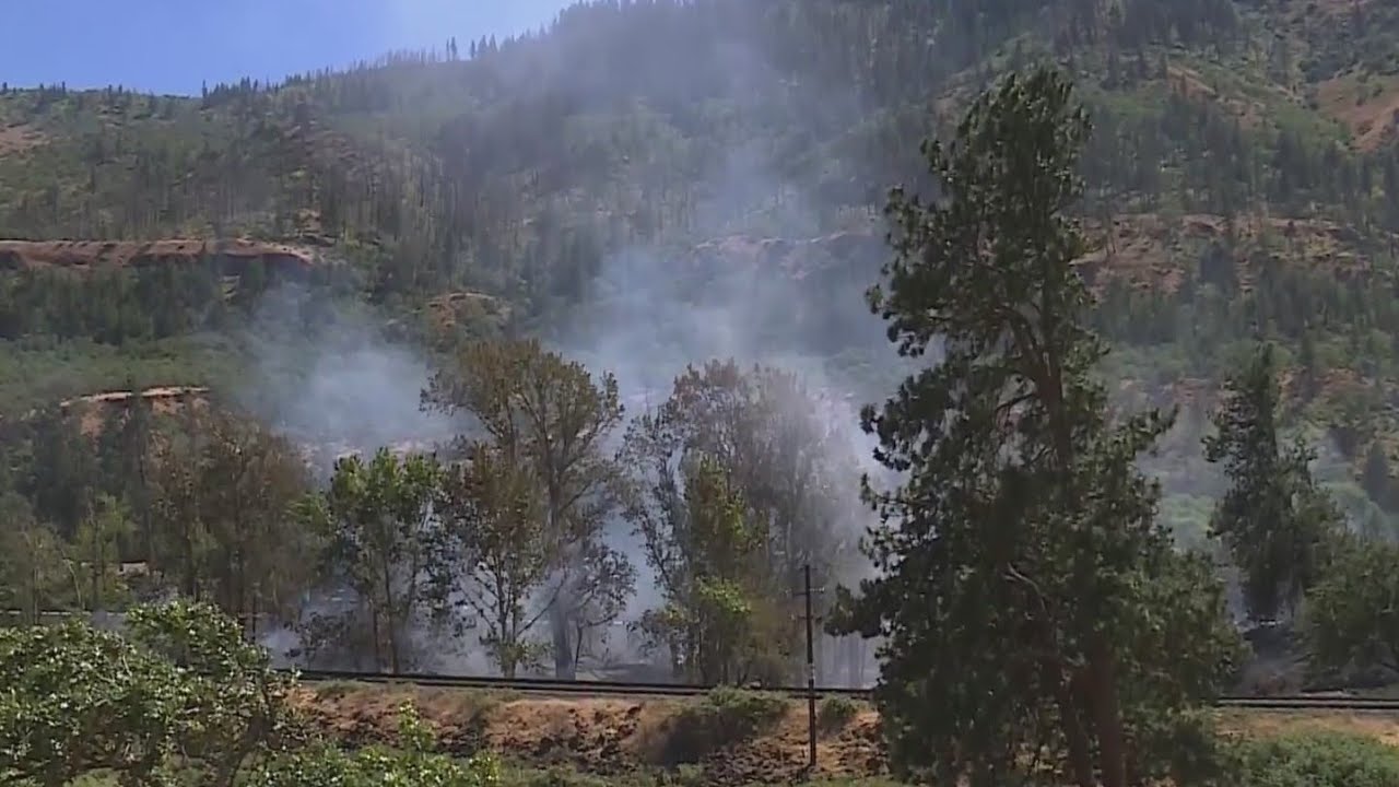 Evacuation levels reduced as crews wrangle Rowena Fire - YouTube